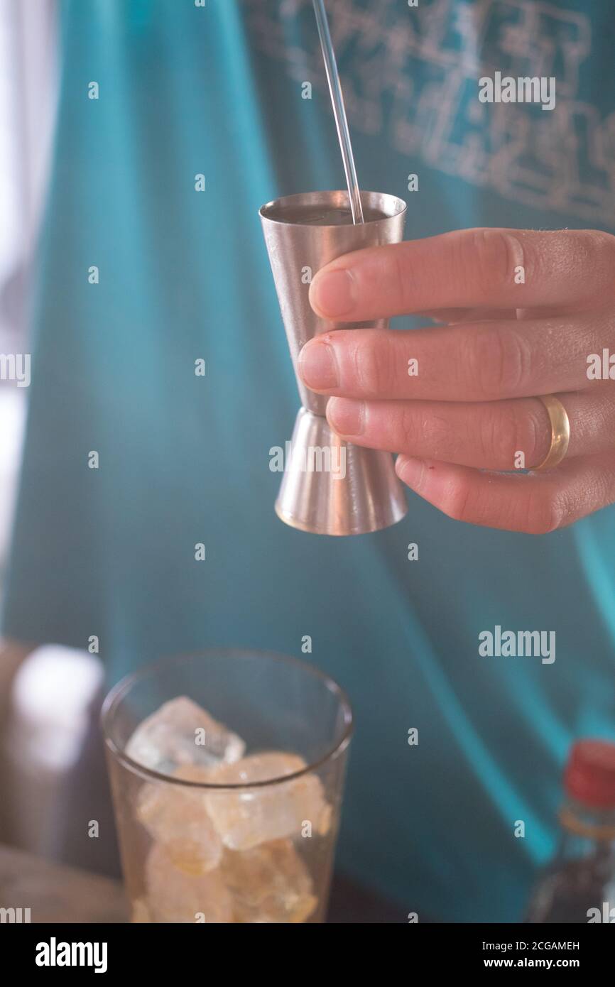 pouring Alcohol into a measuring cup Stock Photo - Alamy