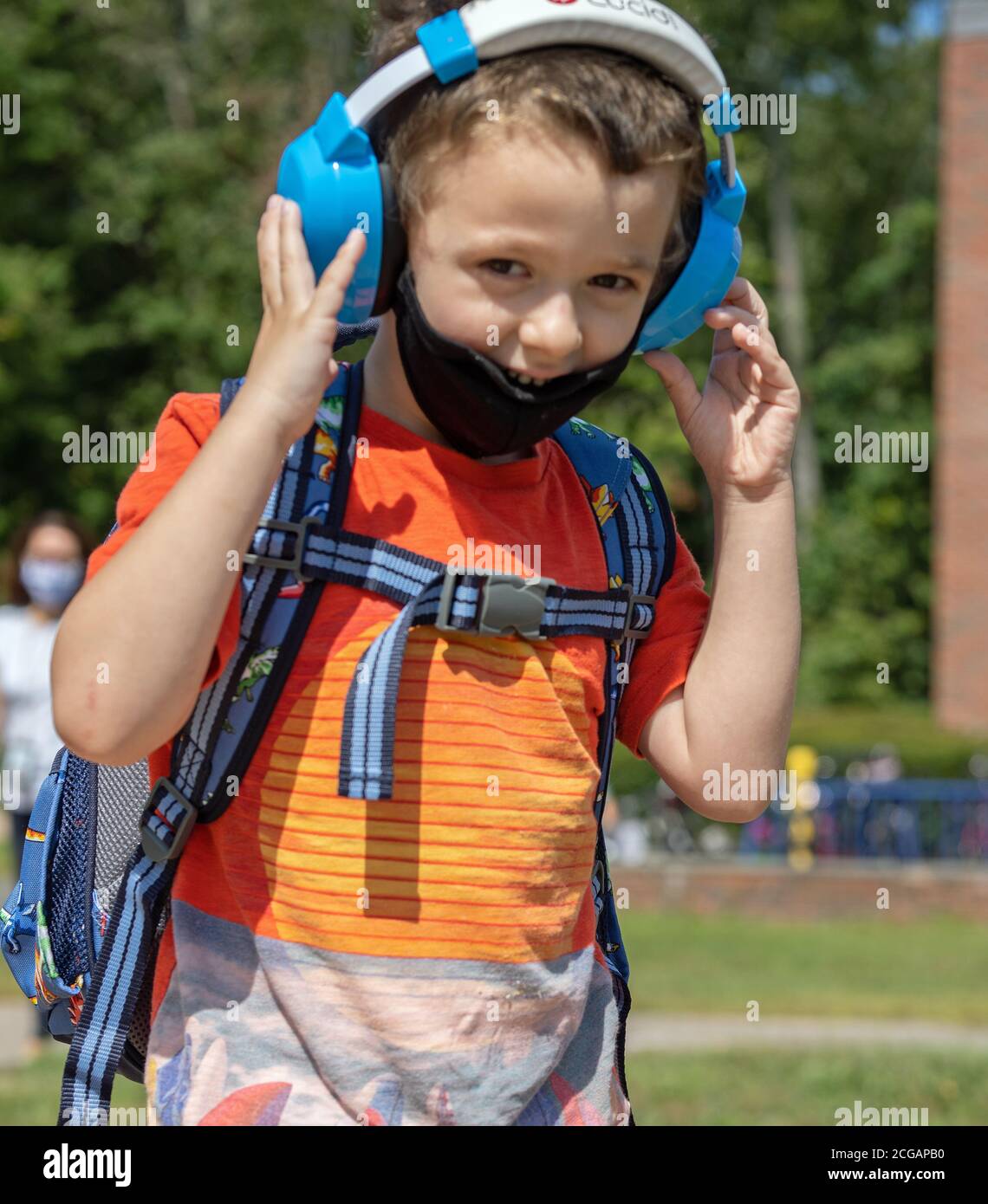 4 year old boy first day back to school wearing facial mask and ...