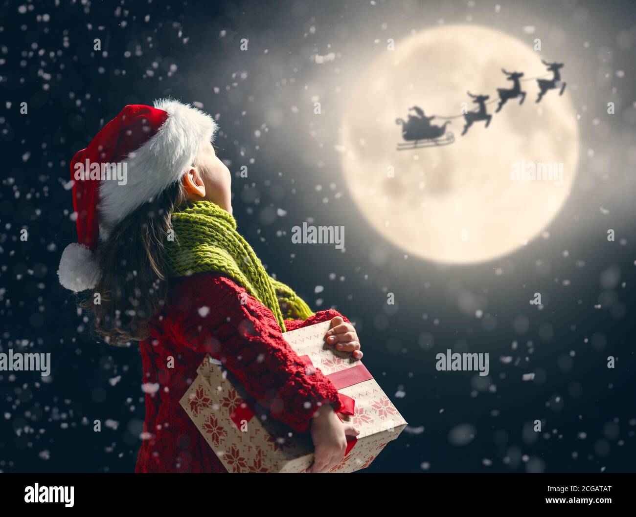 Merry Christmas! Cute little child with xmas present. Santa Claus ...