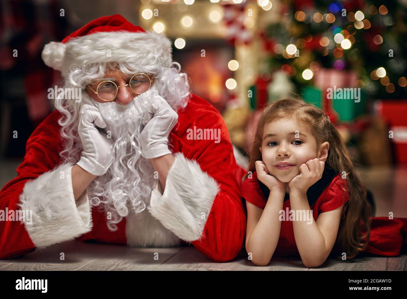 Santa Claus and cute girl getting ready for Christmas Stock Photo - Alamy