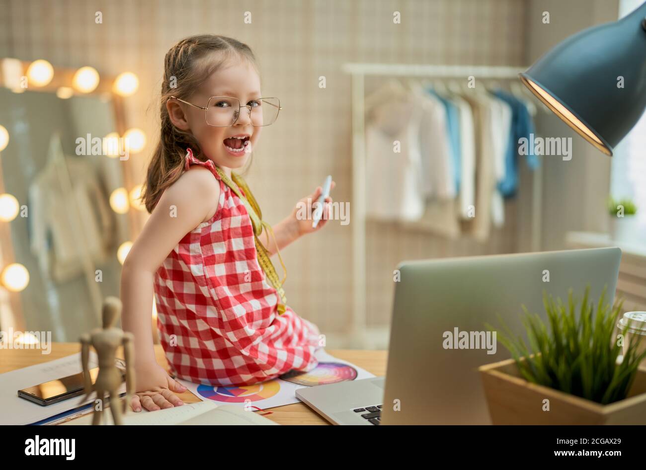 Cute baby girl working on a computer at home Stock Photo - Alamy