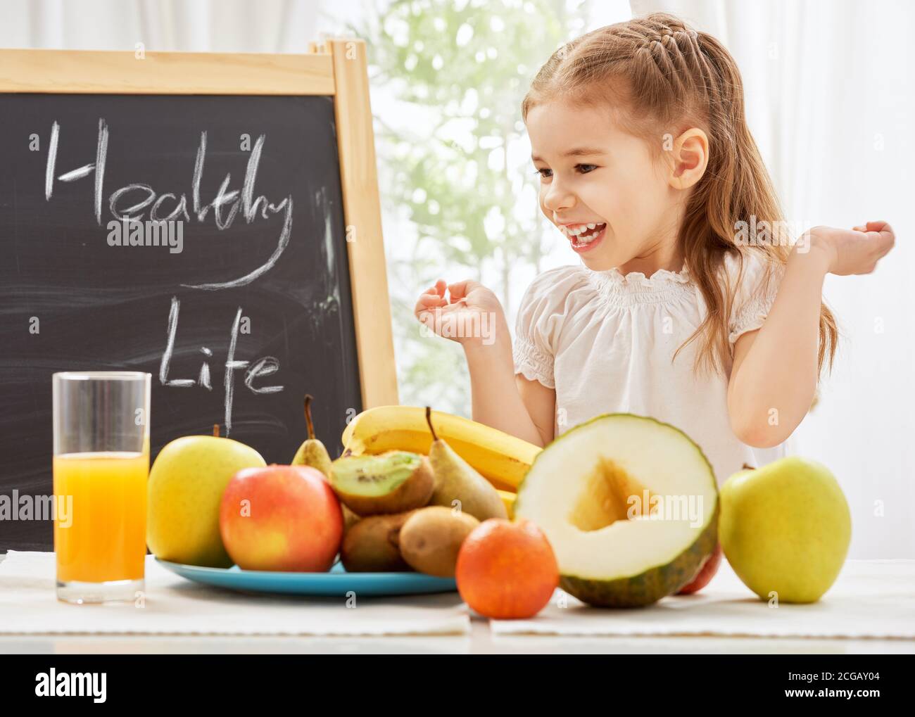 A beautiful girl eating fresh fruit Stock Photo - Alamy