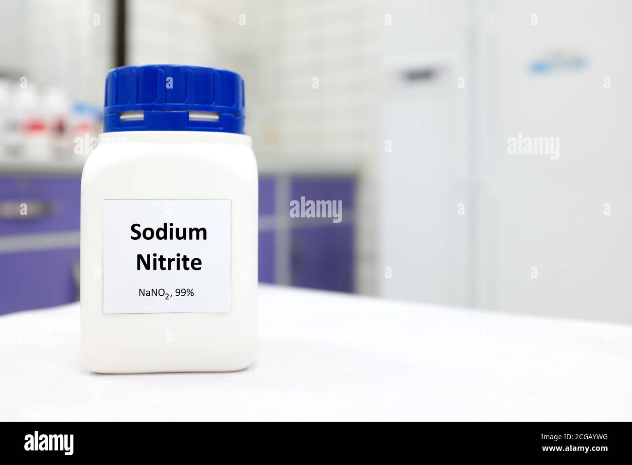 Selective focus of a bottle of sodium nitrite preservative chemical ...