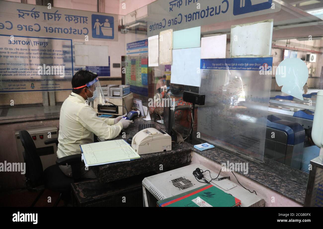 Delhi Metro employee seen at the ticket counter while a passenger ...