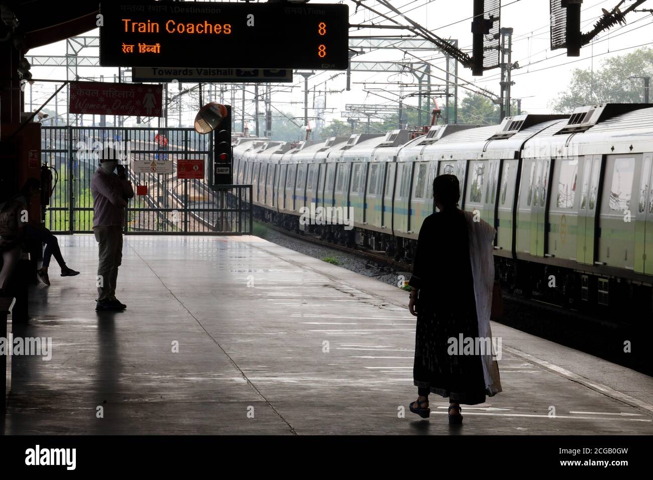 A passenger waits for the metro on Blue line between Dwarka Sec -21 to ...