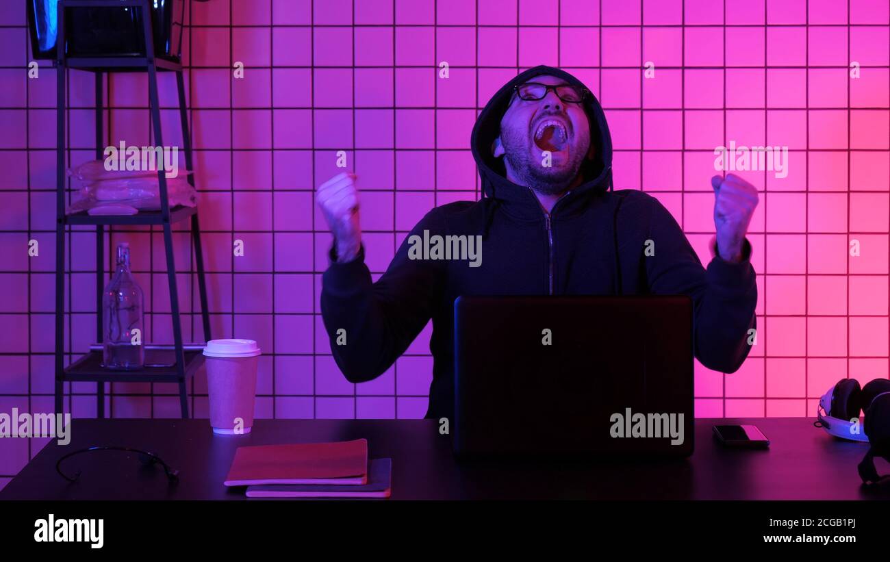 Happy young man in eyeglasses watching computer game. Emotional ...