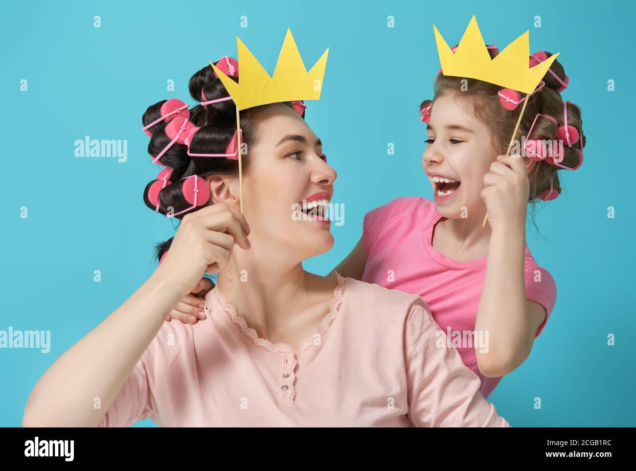 Funny family! Mother and her child daughter with a paper accessories ...