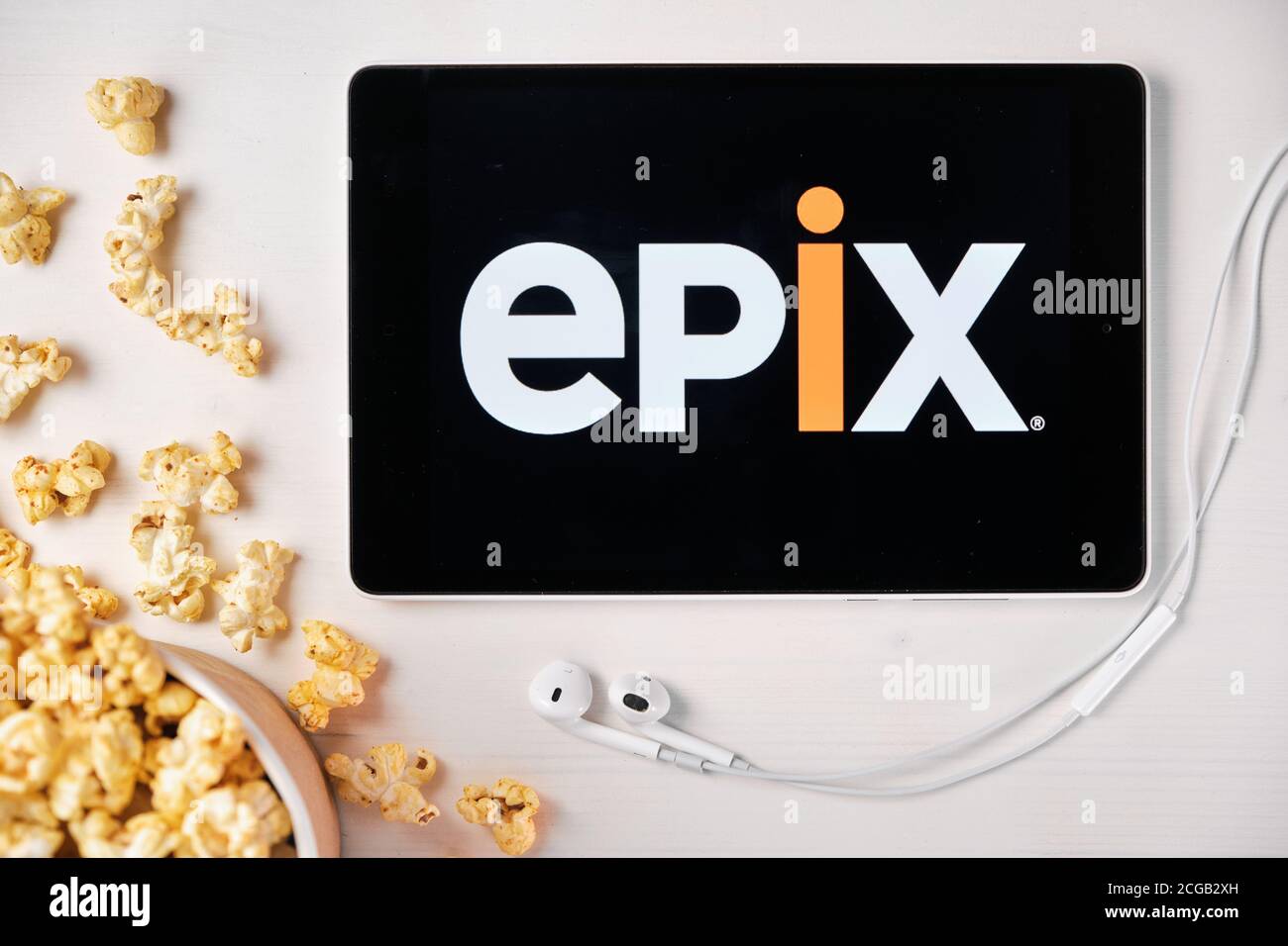 Epix logo on the tablet screen laying on the white table with scattered ...