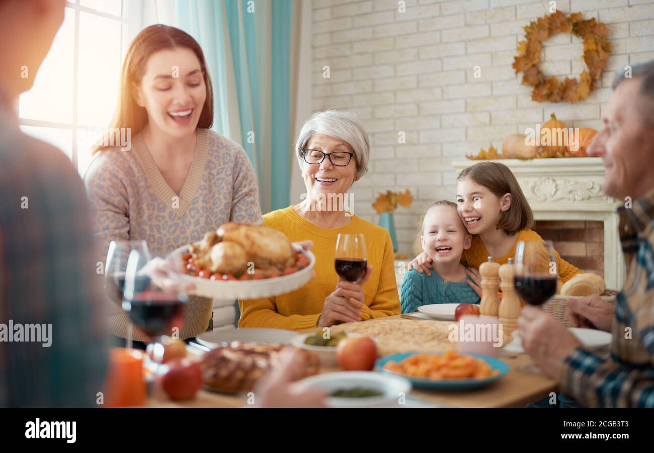 Happy Thanksgiving Day! Autumn feast. Family sitting at the table and ...