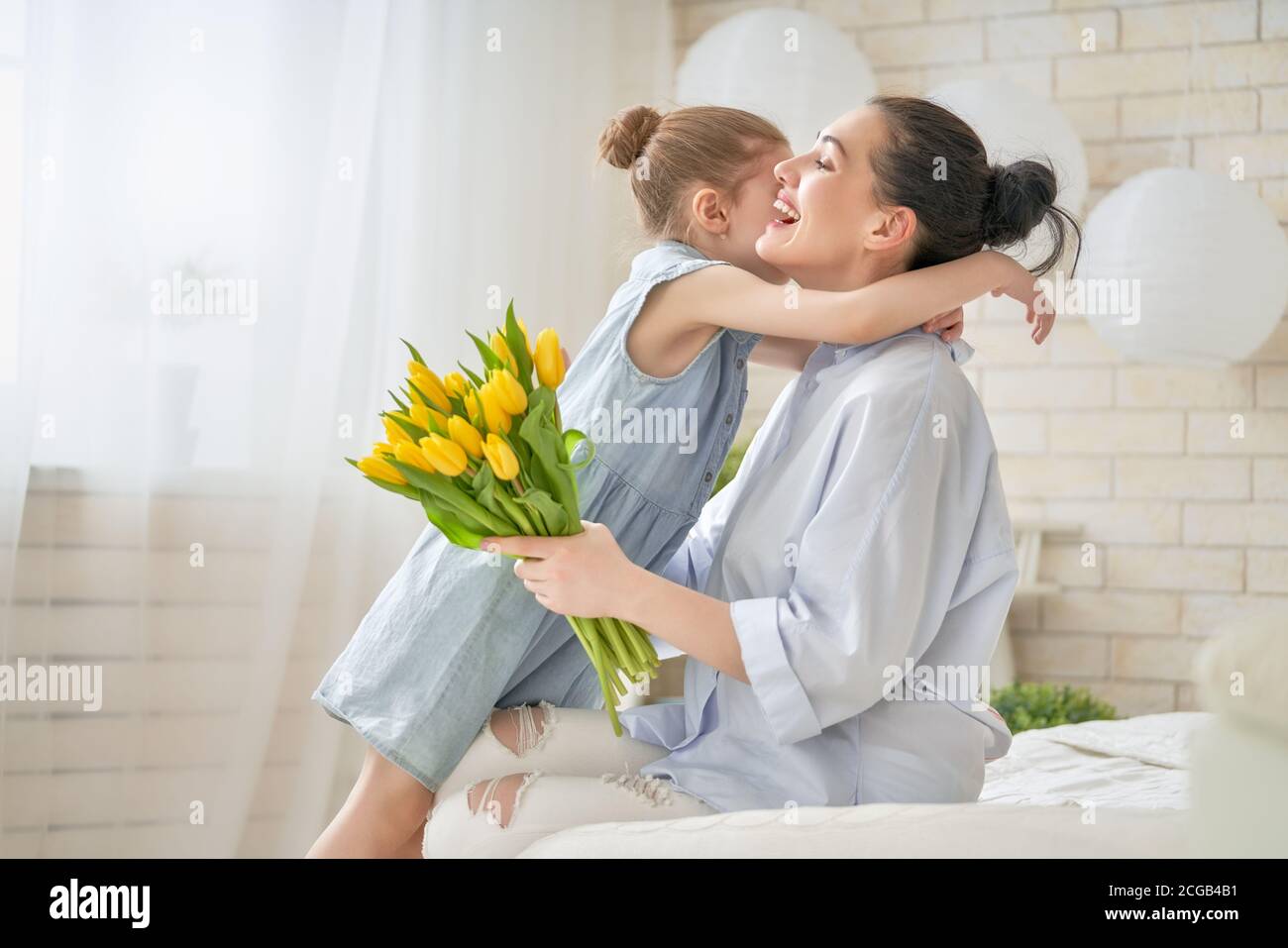 Happy mother's day! Child daughter is congratulating mom and giving her ...