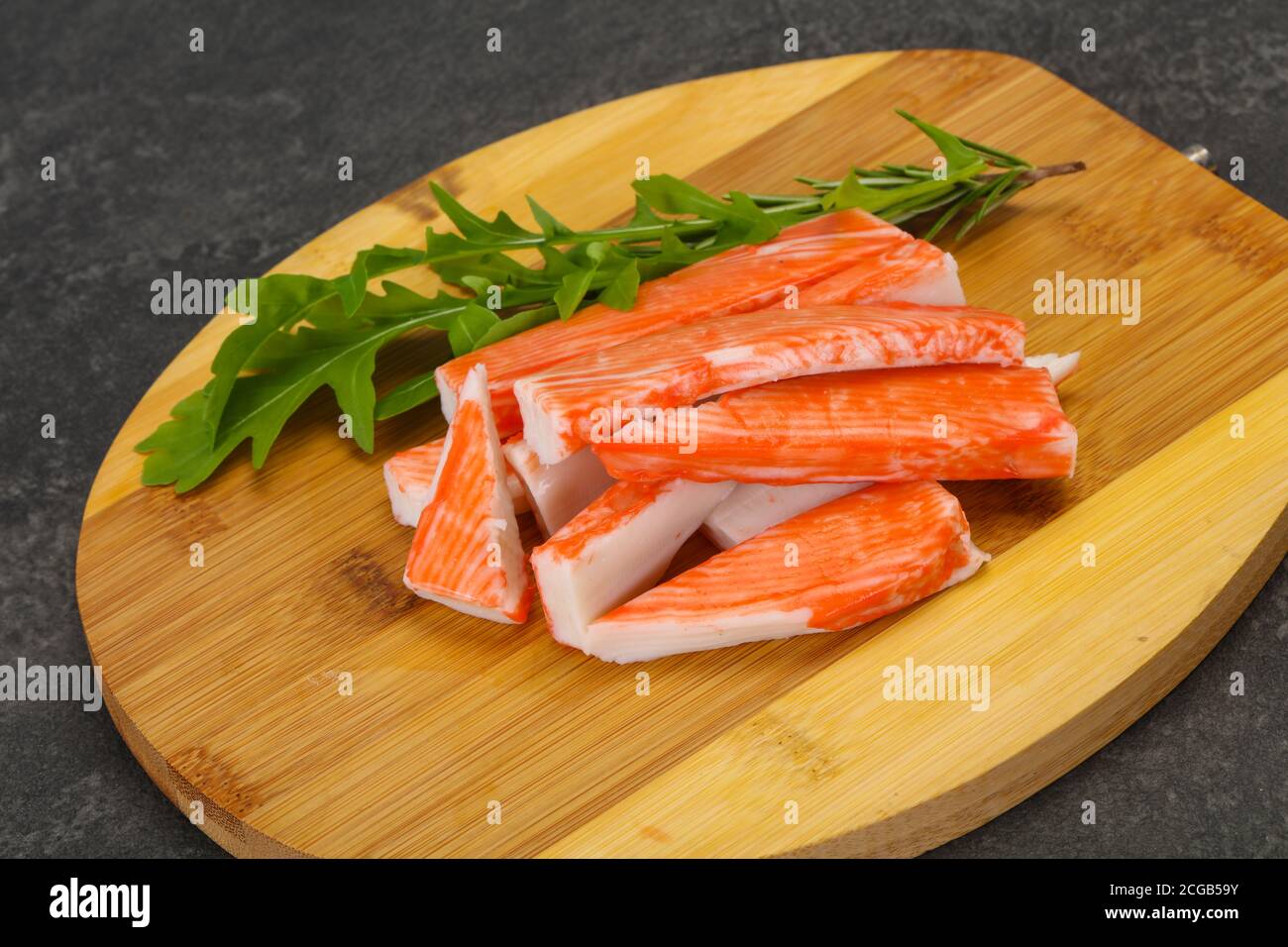 Crab stick surimi over wooden board Stock Photo - Alamy