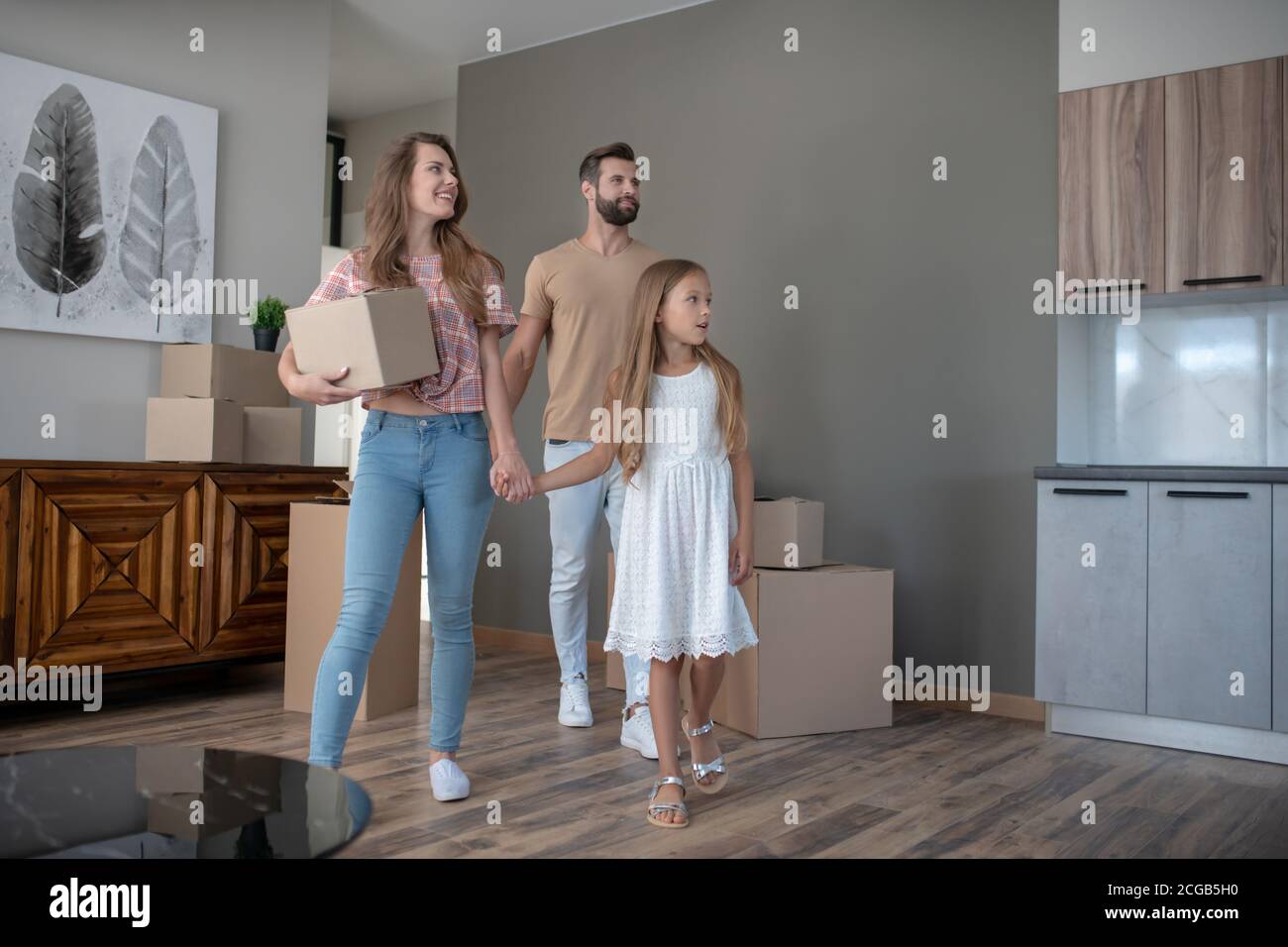 Young cute family moving to the new aprtment Stock Photo - Alamy