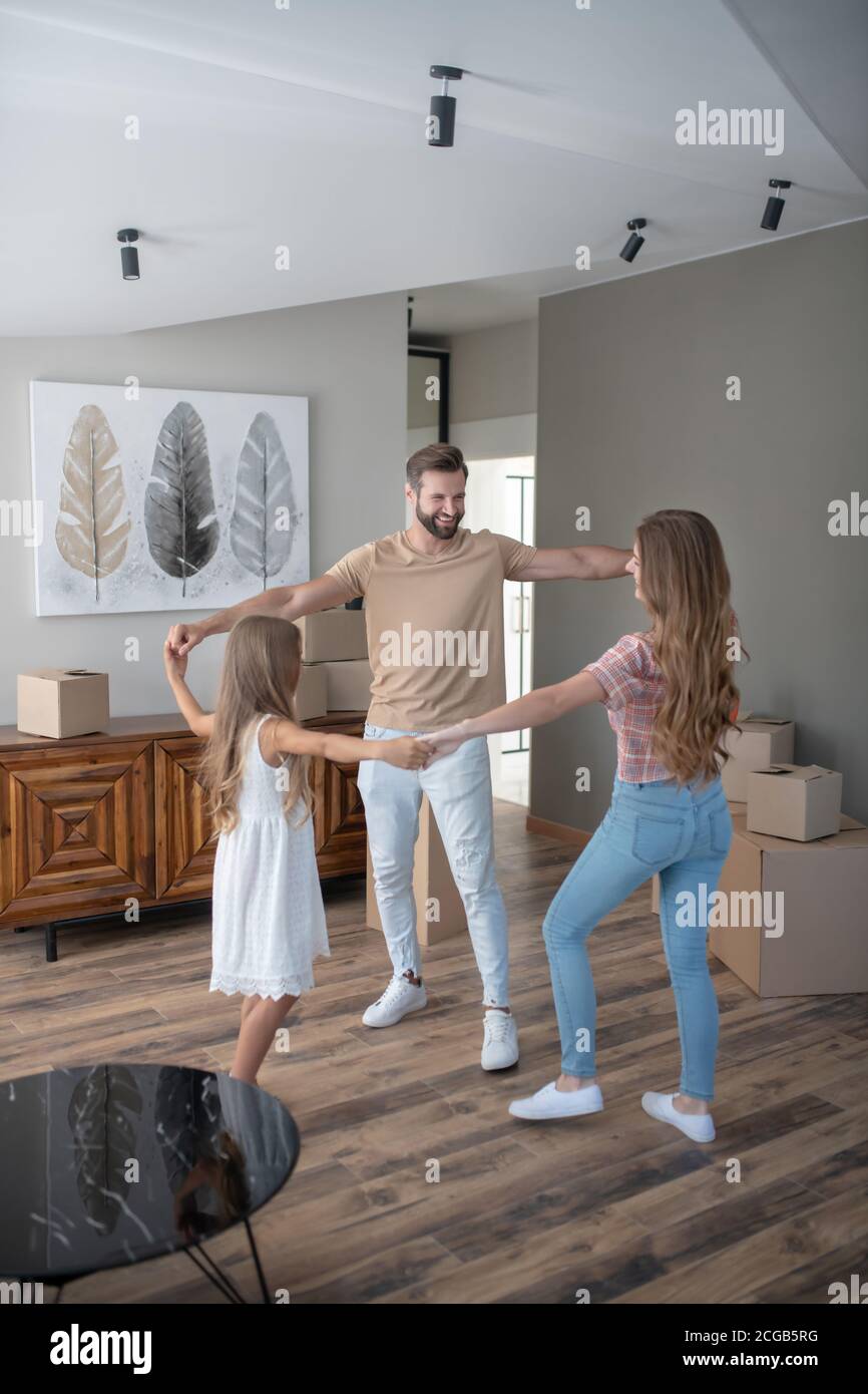 Parents and daughter dancing and feeling amazing Stock Photo - Alamy