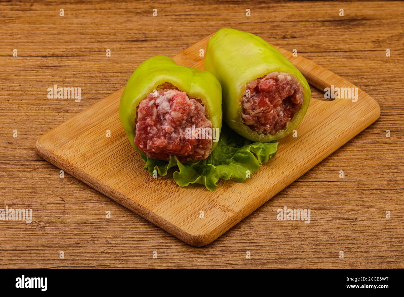 Raw stuffed green bell pepper with meat Stock Photo - Alamy