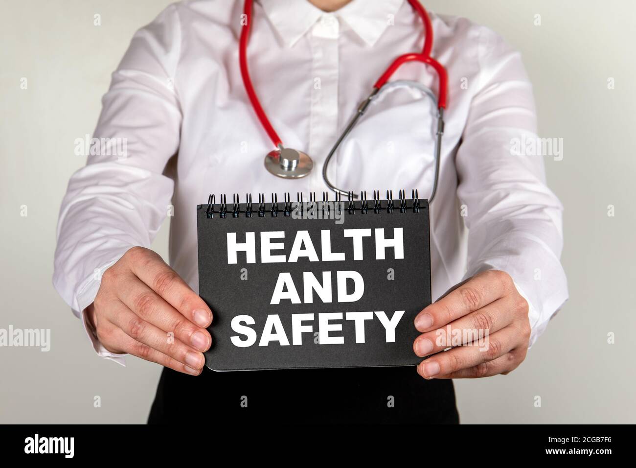 HEALTH AND SAFETY. Female doctor with stethoscope and notepad Stock ...