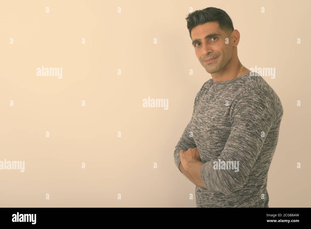 Young muscular Persian man against white background Stock Photo - Alamy