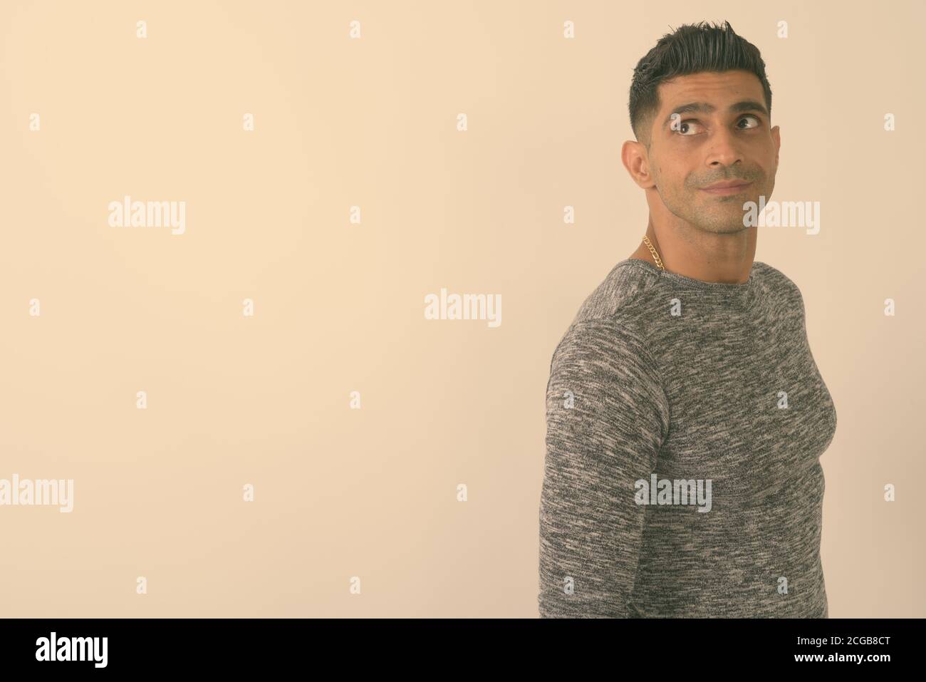 Young muscular Persian man against white background Stock Photo - Alamy