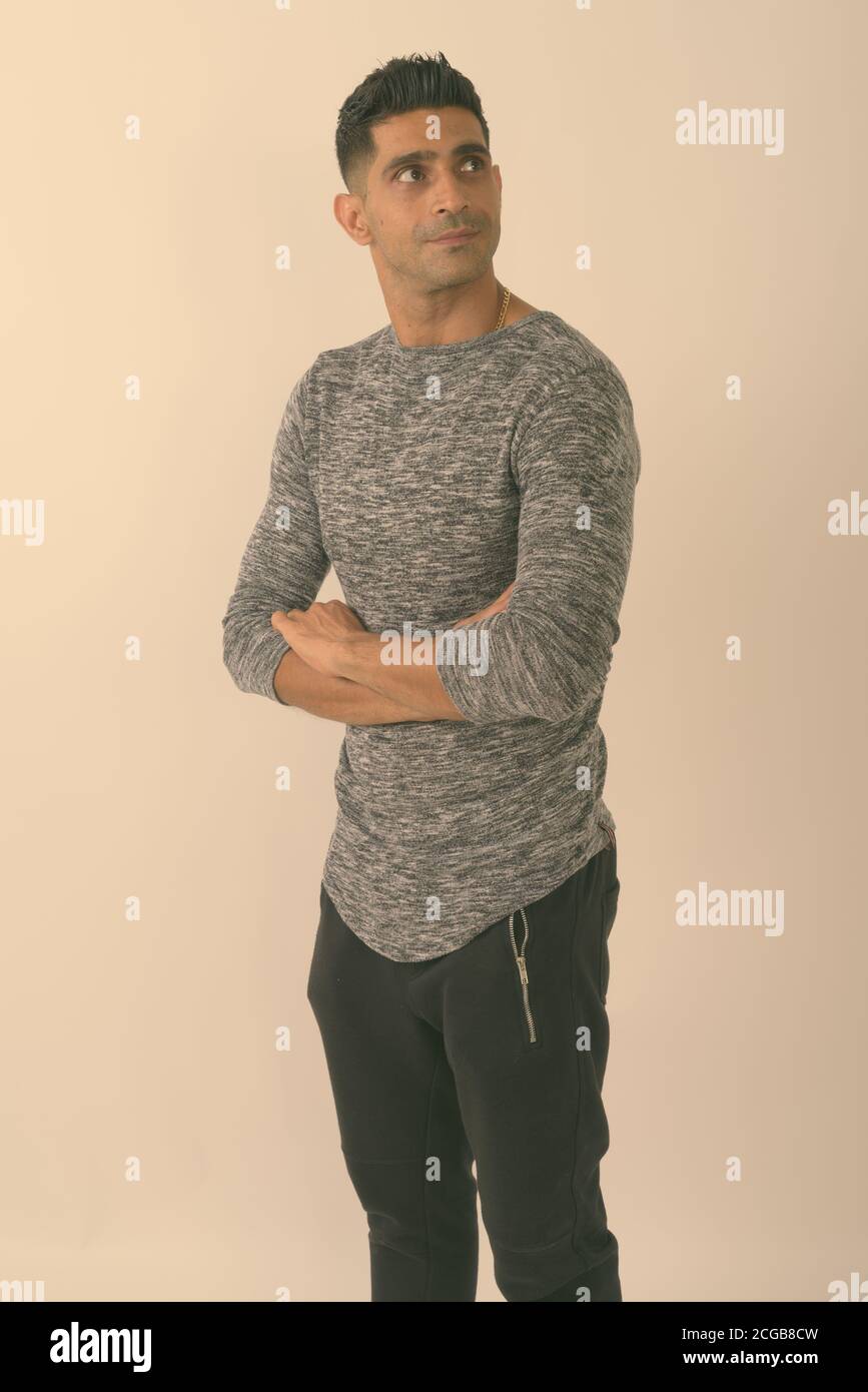 Young muscular Persian man against white background Stock Photo - Alamy