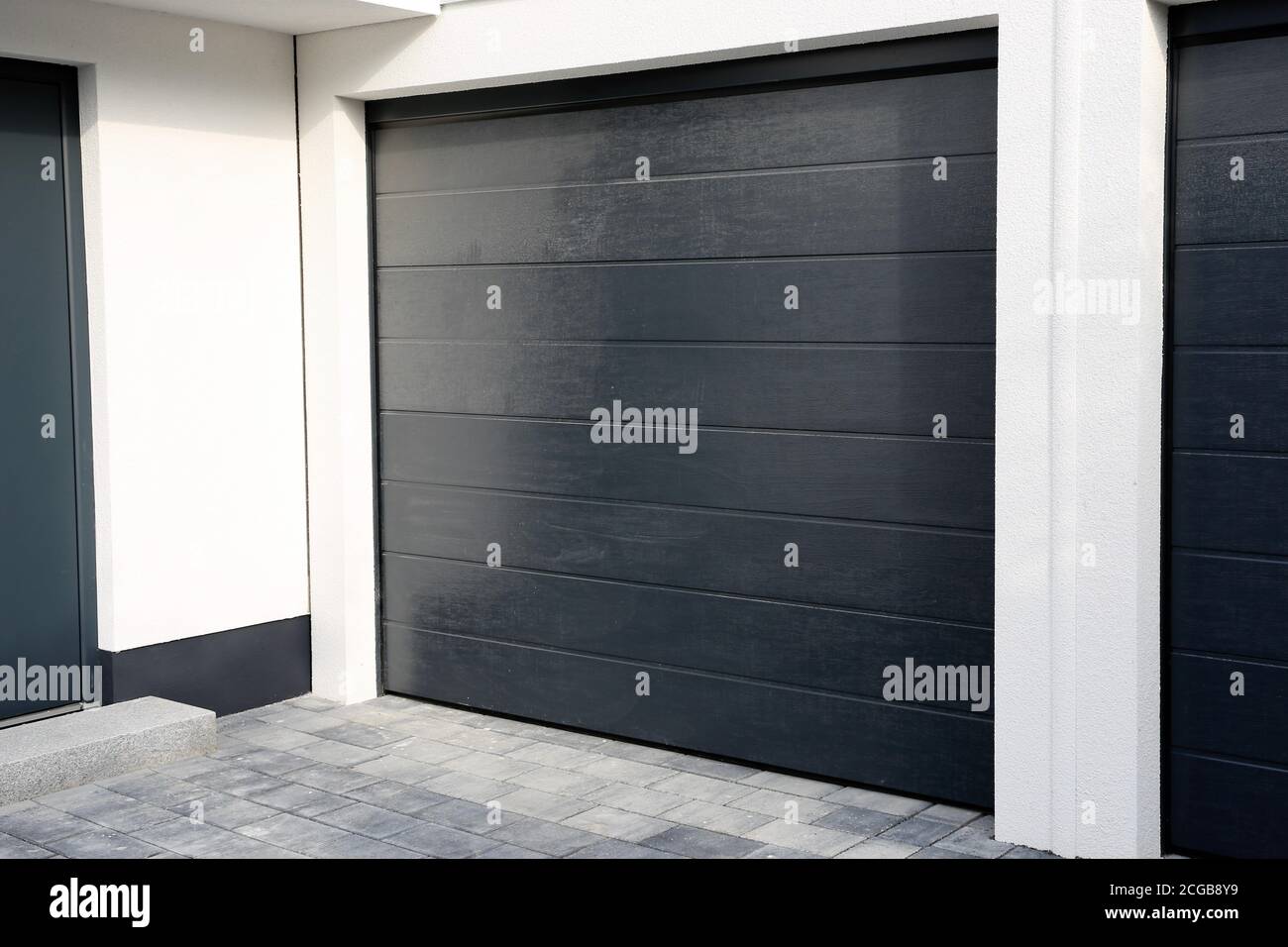 Modern new garage door (sectional door Stock Photo - Alamy