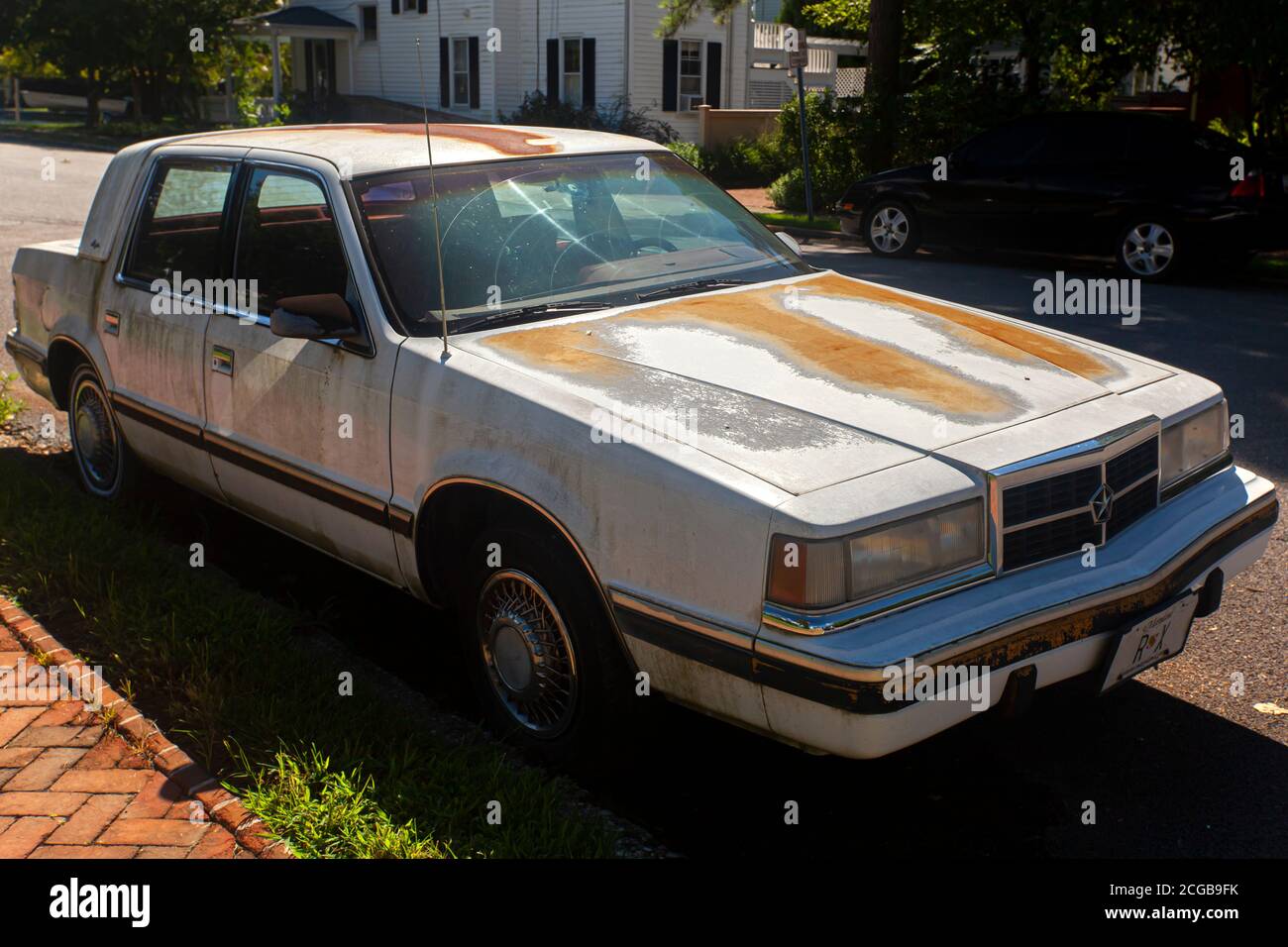 Chestertown, MD, USA 08/30/2020: Side view of a very old white rusty ...
