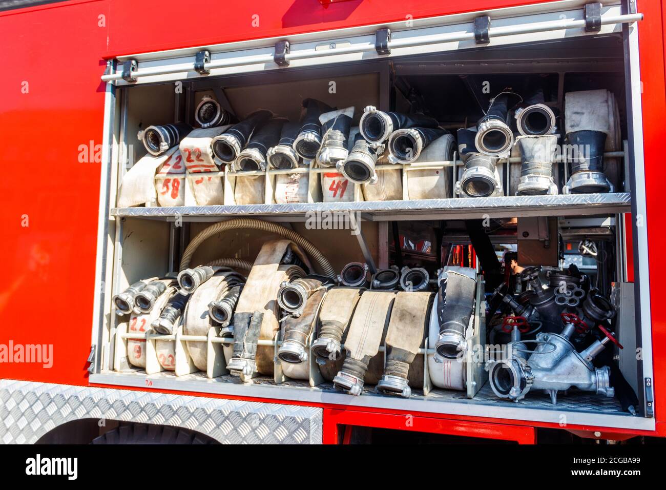 Rescue fire truck equipment. Compartment of the rolled up fire hoses on ...