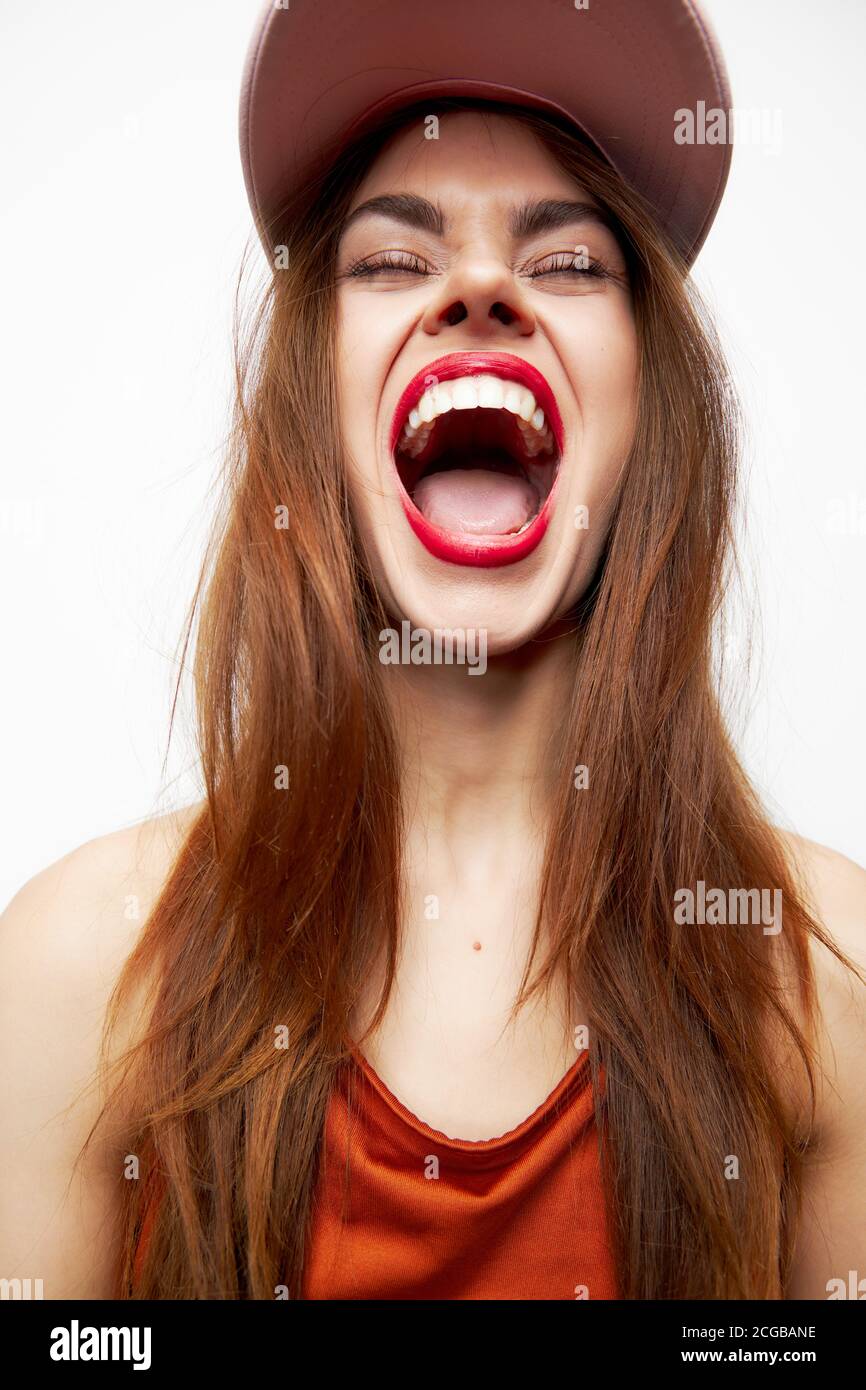 Portrait of a woman in a cap Open mouth tongue closed eyes fun red lips ...