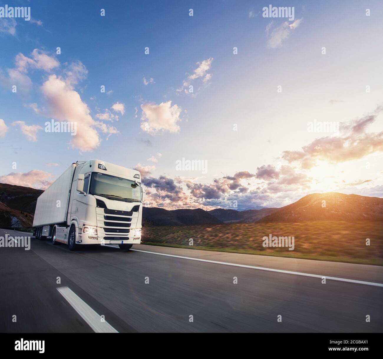 European truck vehicle on motorway with dramatic sunset light. Cargo ...