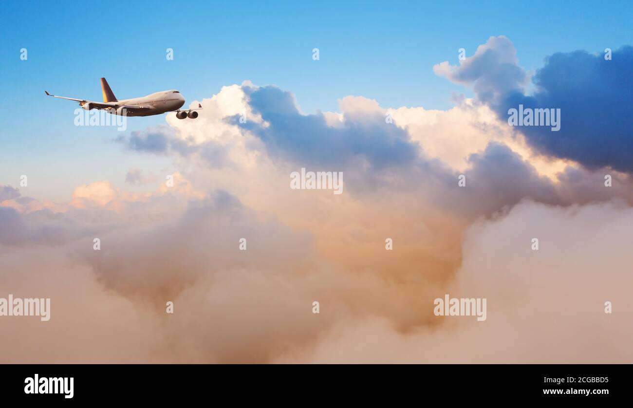 Huge commercial airplane flying over dramatic sunset sky. Jet plane is ...