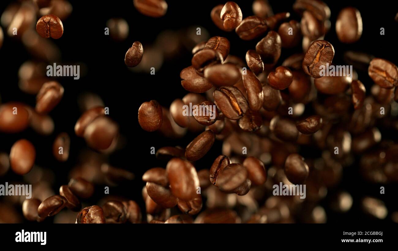 Fresh roasted coffee beans flying in the air, isolated on black ...