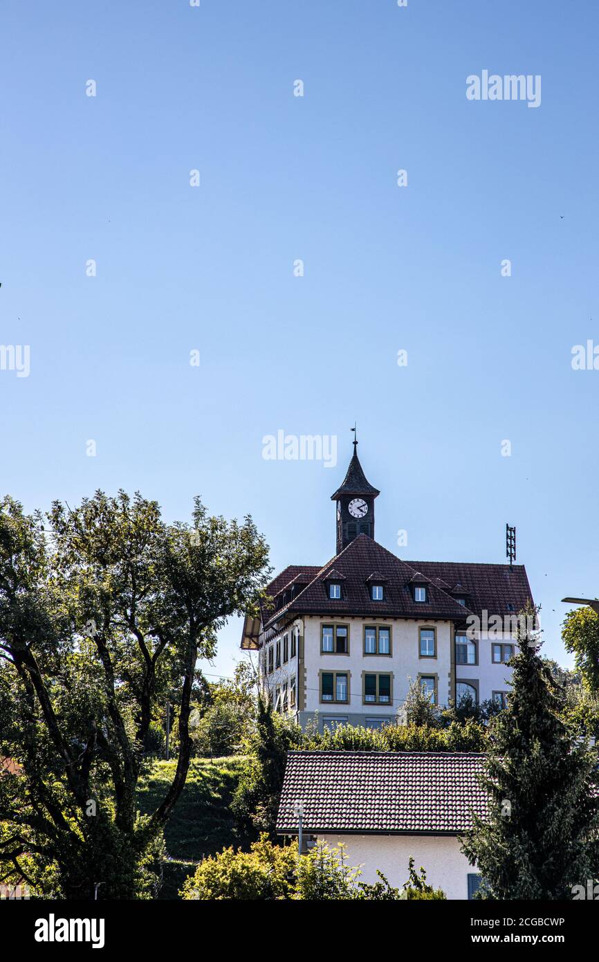 Old school in mittle of trees on a hill Stock Photo - Alamy