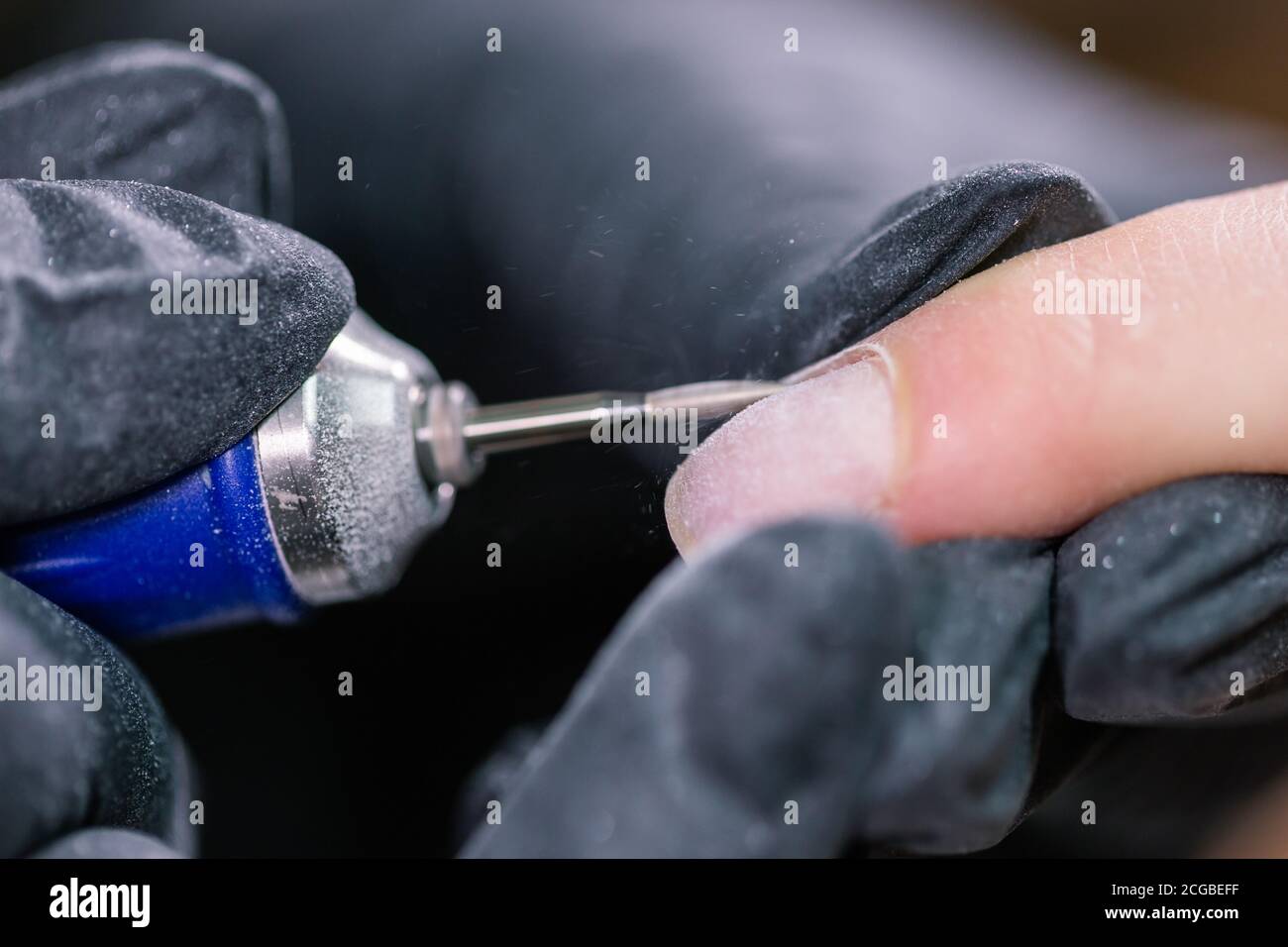 Manicurist use electric nail file drill in beauty salon. Perfect nails ...