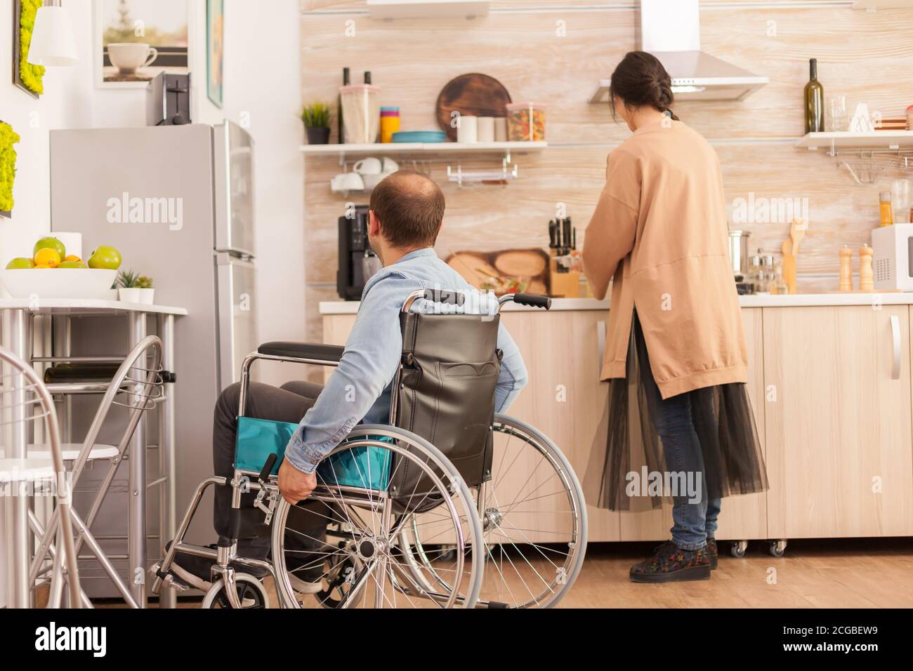Woman in wheelchair cooking meal hi-res stock photography and images ...