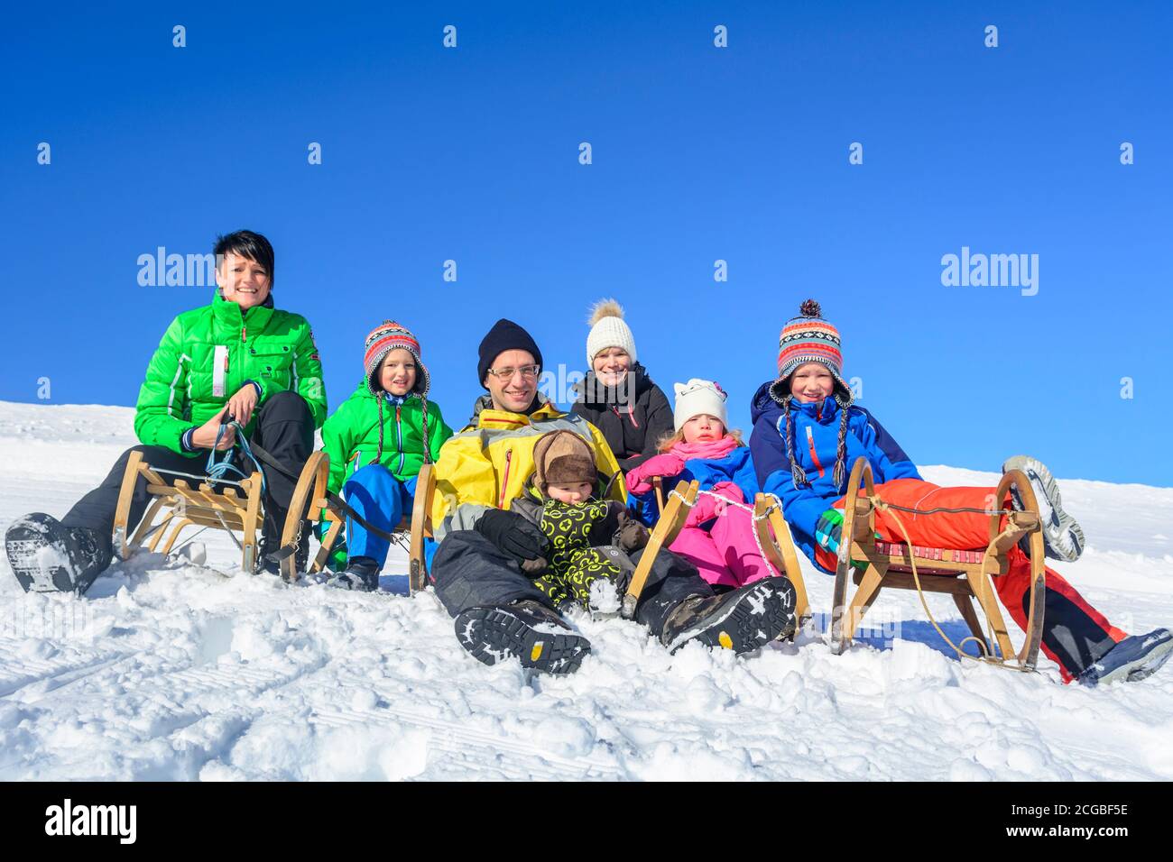 Funny afternoon in wintertime on sleigh slope Stock Photo - Alamy