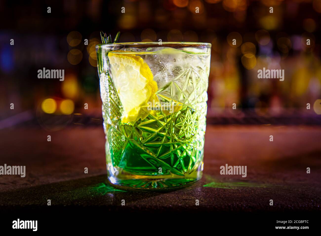 A green cocktail in an old fashion glass is on the bar Stock Photo - Alamy