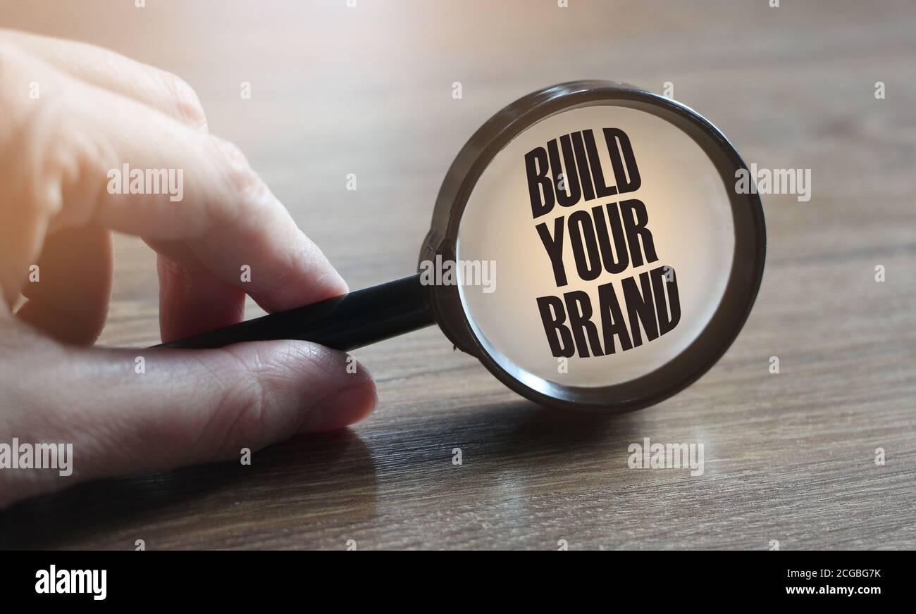magnifying glass with text Build Your Brand. Marketing business concept ...