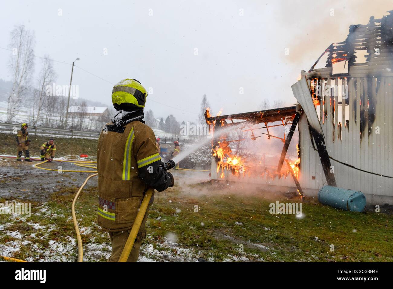 Norwegian first responder firefighter from behind trying to put out ...