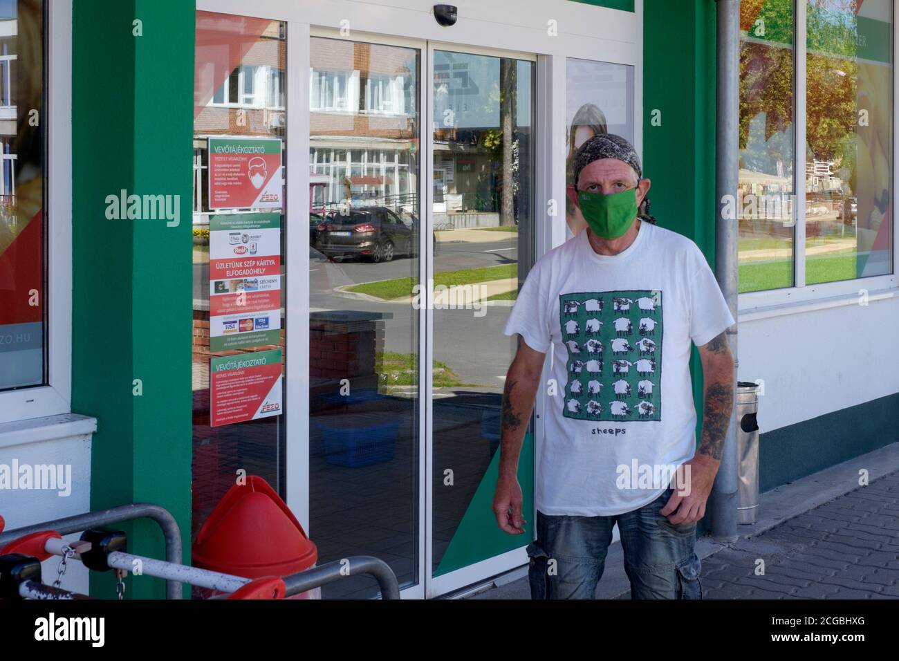 masked older man standing outside of supermarket wearing sheep t.shirt ...