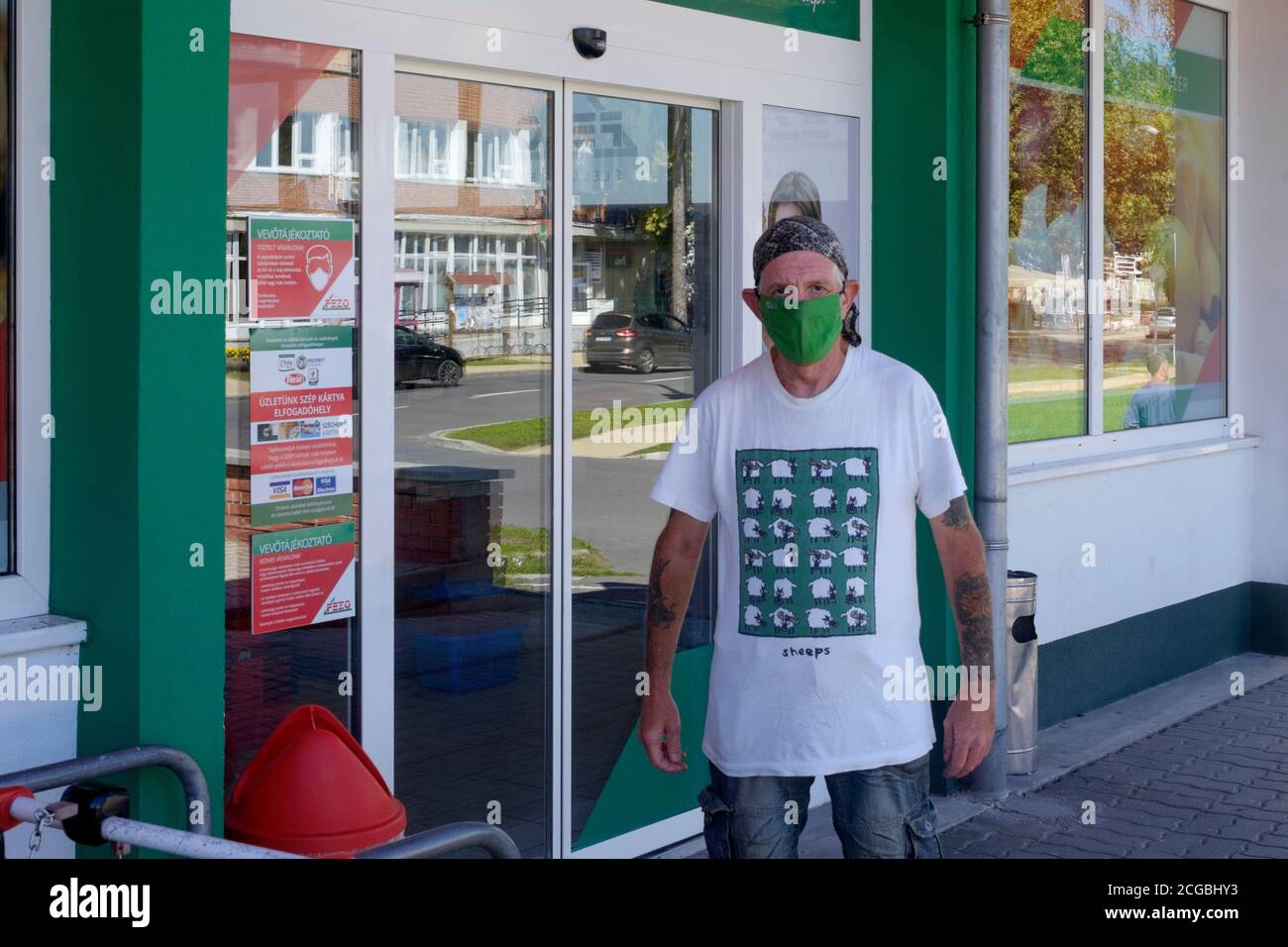 masked older man standing outside of supermarket wearing sheep t.shirt ...