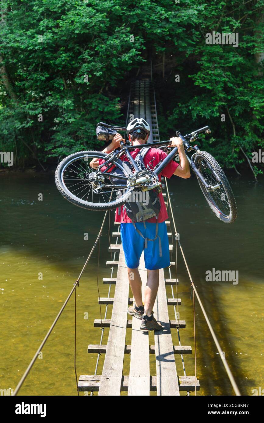 Man crossing rope bridge in hi-res stock photography and images - Alamy