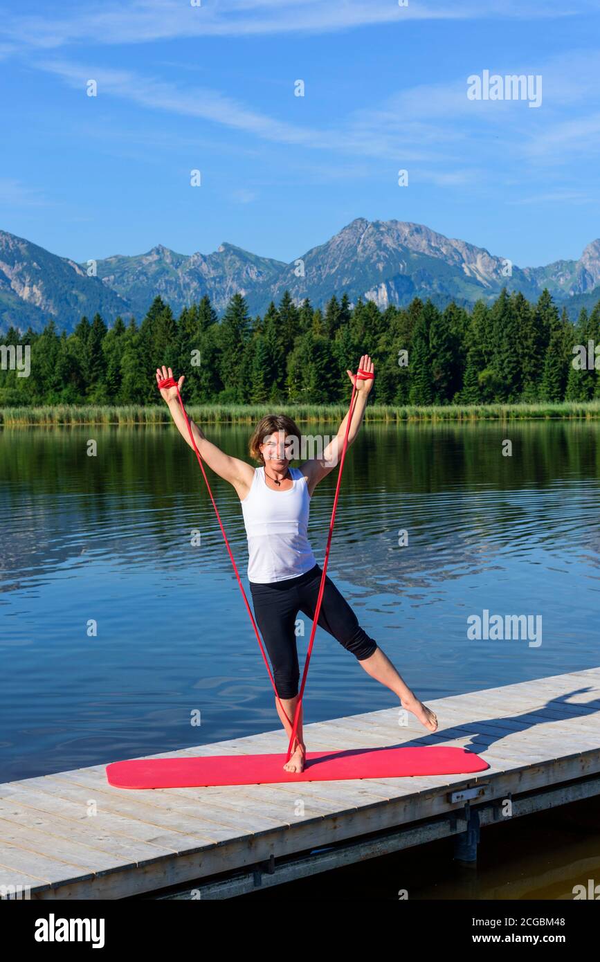 Pilates excercises on a landing stage in summer Stock Photo - Alamy