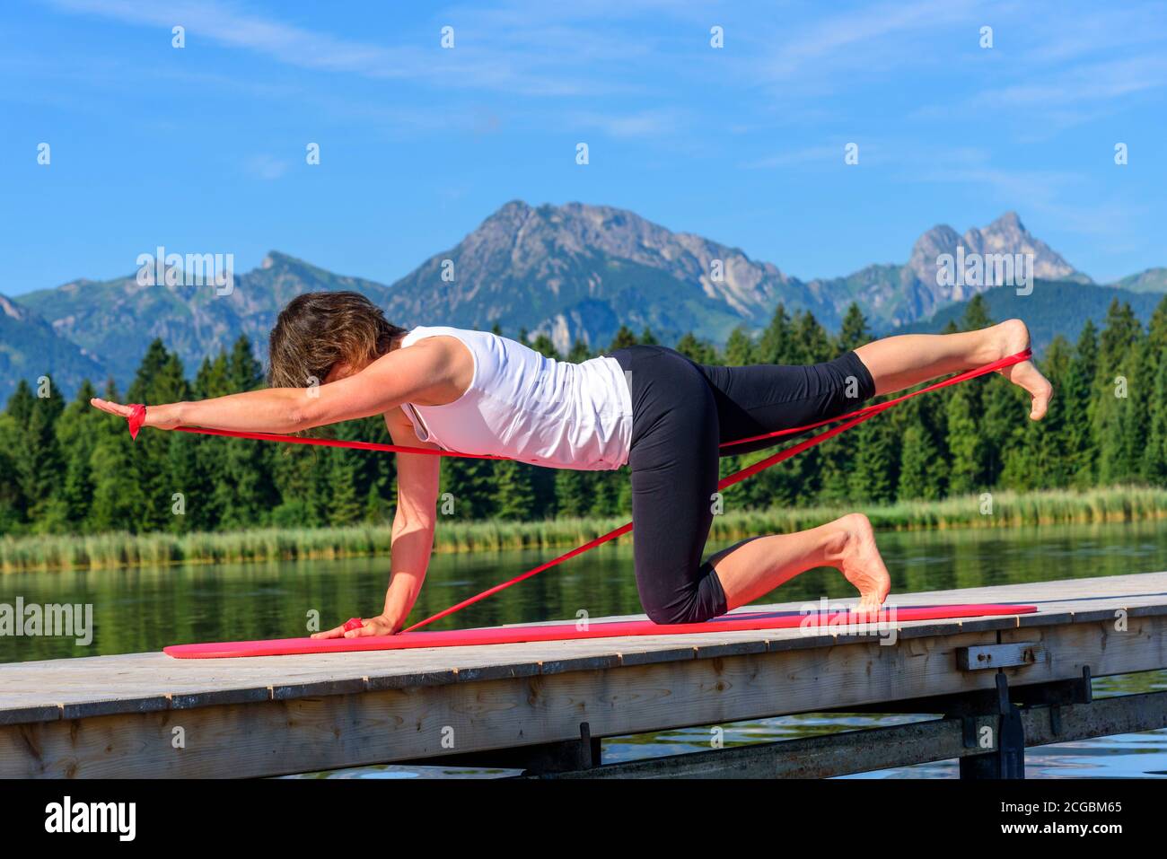 Pilates excercises on a landing stage in summer Stock Photo - Alamy