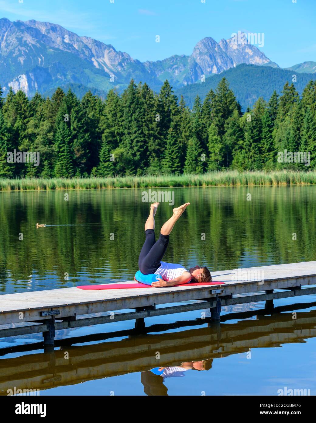 Pilates excercises on a landing stage in summer Stock Photo - Alamy