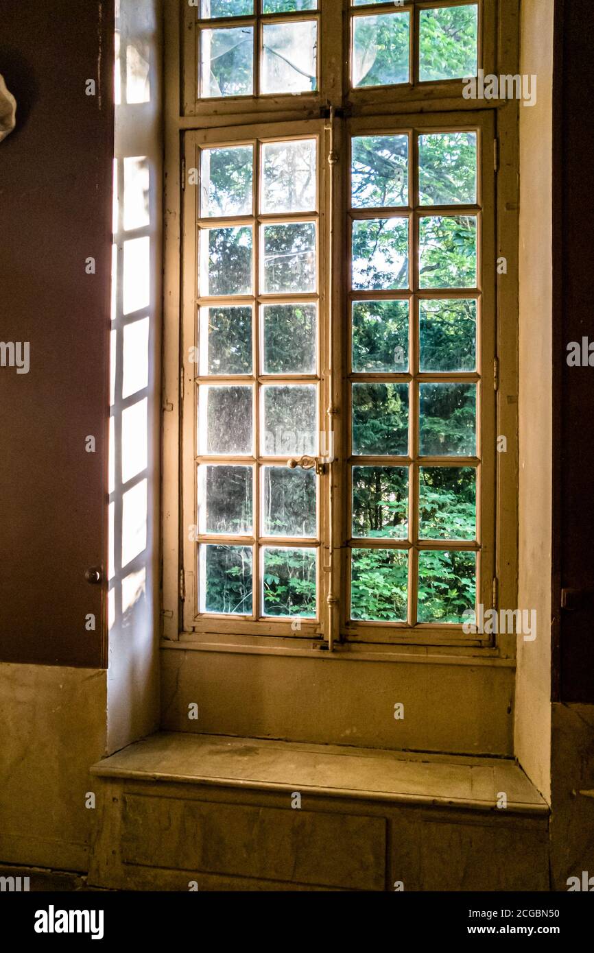 View through the window with bars on the green Park Stock Photo - Alamy