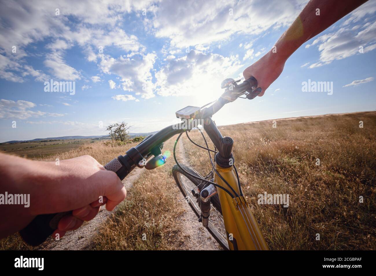 Bike handle bar with lake and sunshine in the background. focus on bike ...