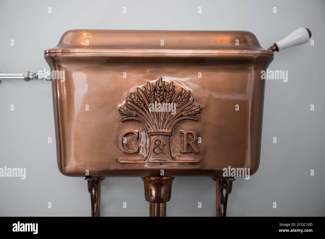 Brass and copperware wall cistern in the bathroom of a Victorian house ...