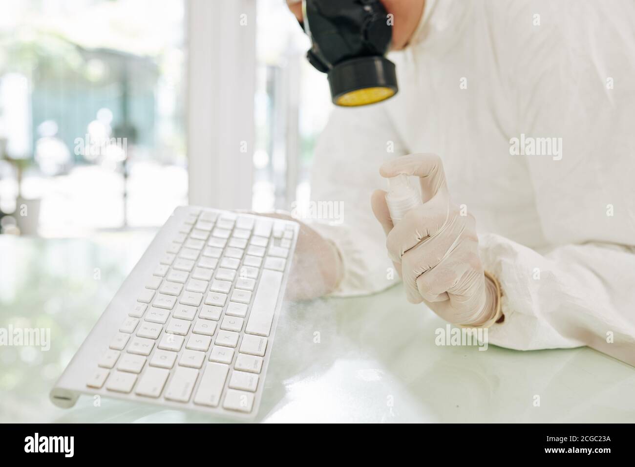 Service worker spraying keyboard Stock Photo - Alamy