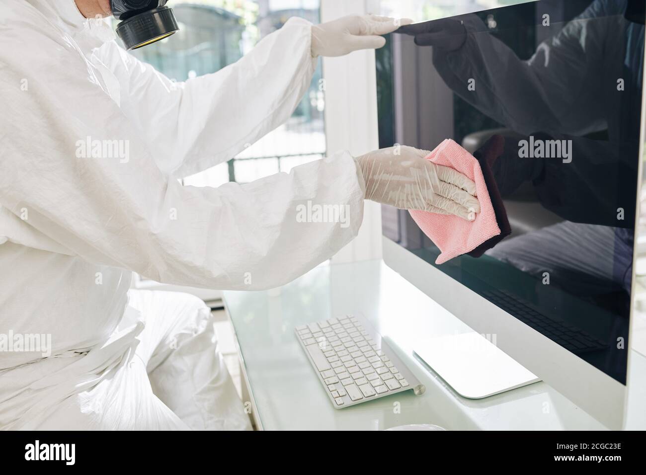 Worker wiping computer screen Stock Photo - Alamy