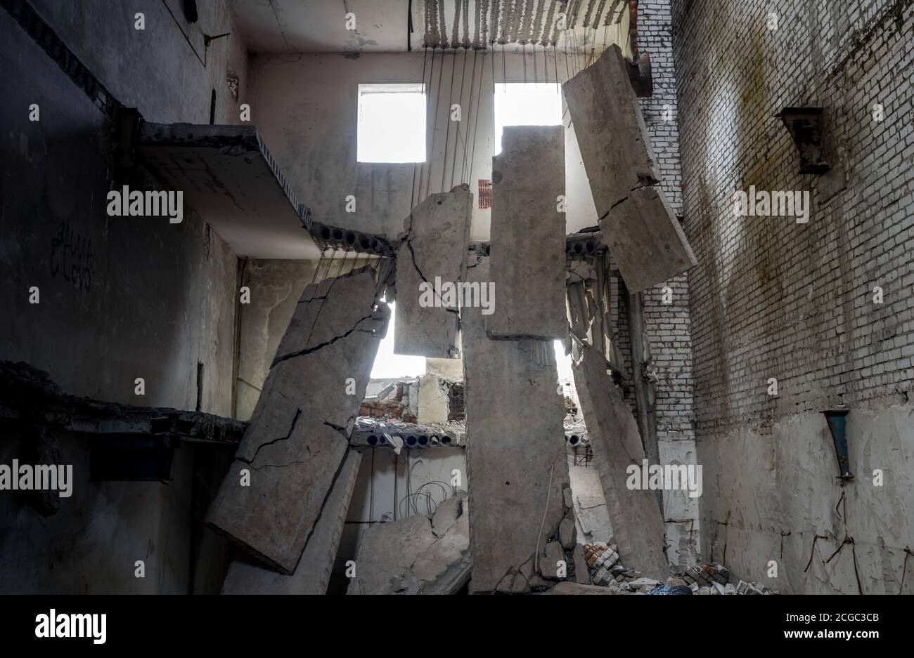 Destroyed concrete building inside with a pile of construction debris ...
