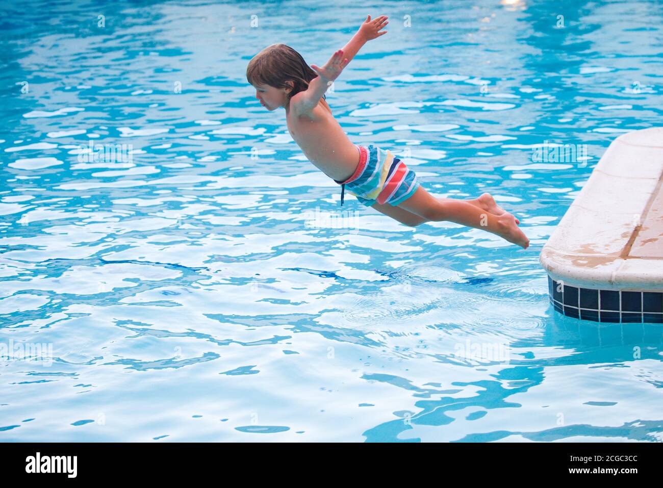 Kids jumping in pool. Happy child swimming in the pool Stock Photo - Alamy