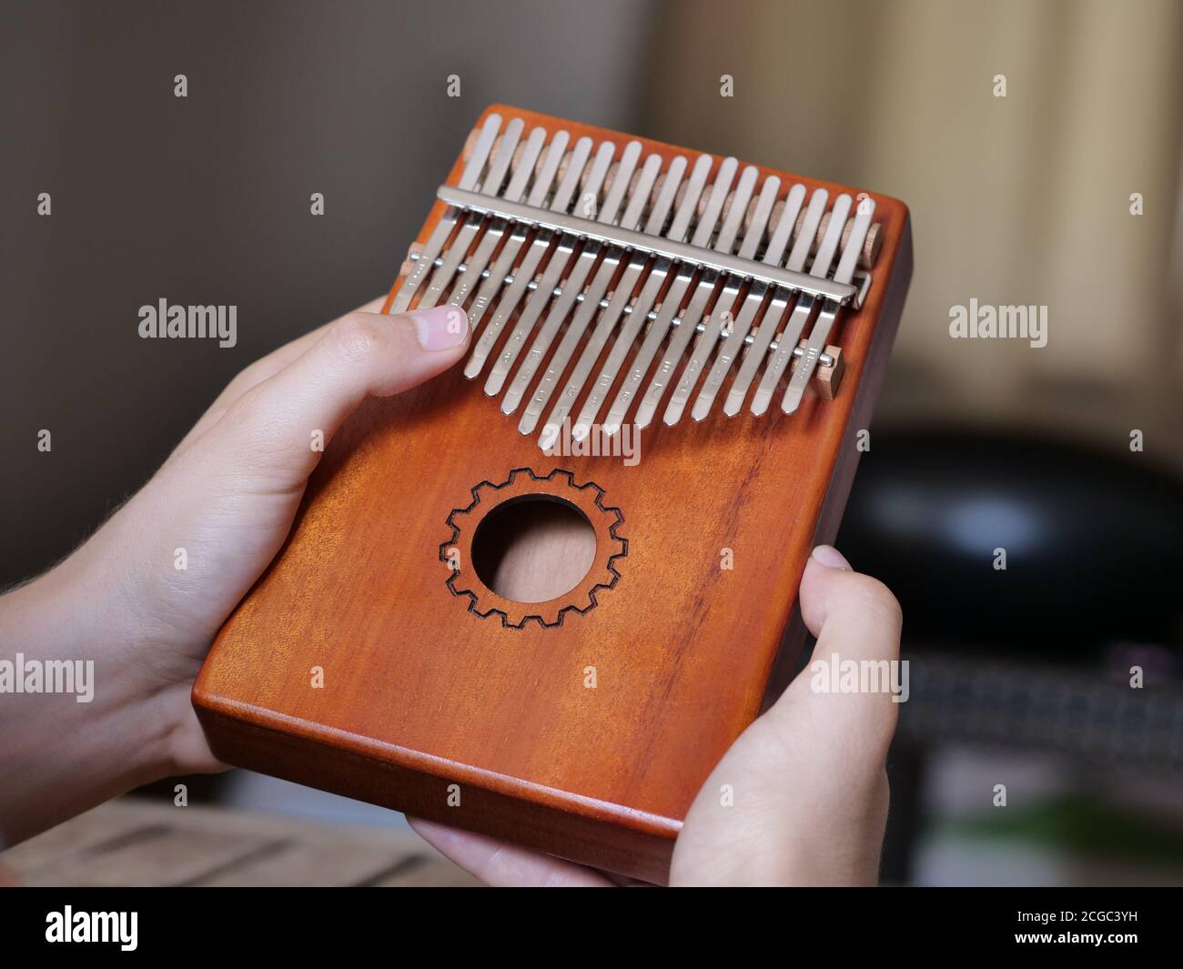 Close up of hands holding Kalimba Stock Photo - Alamy